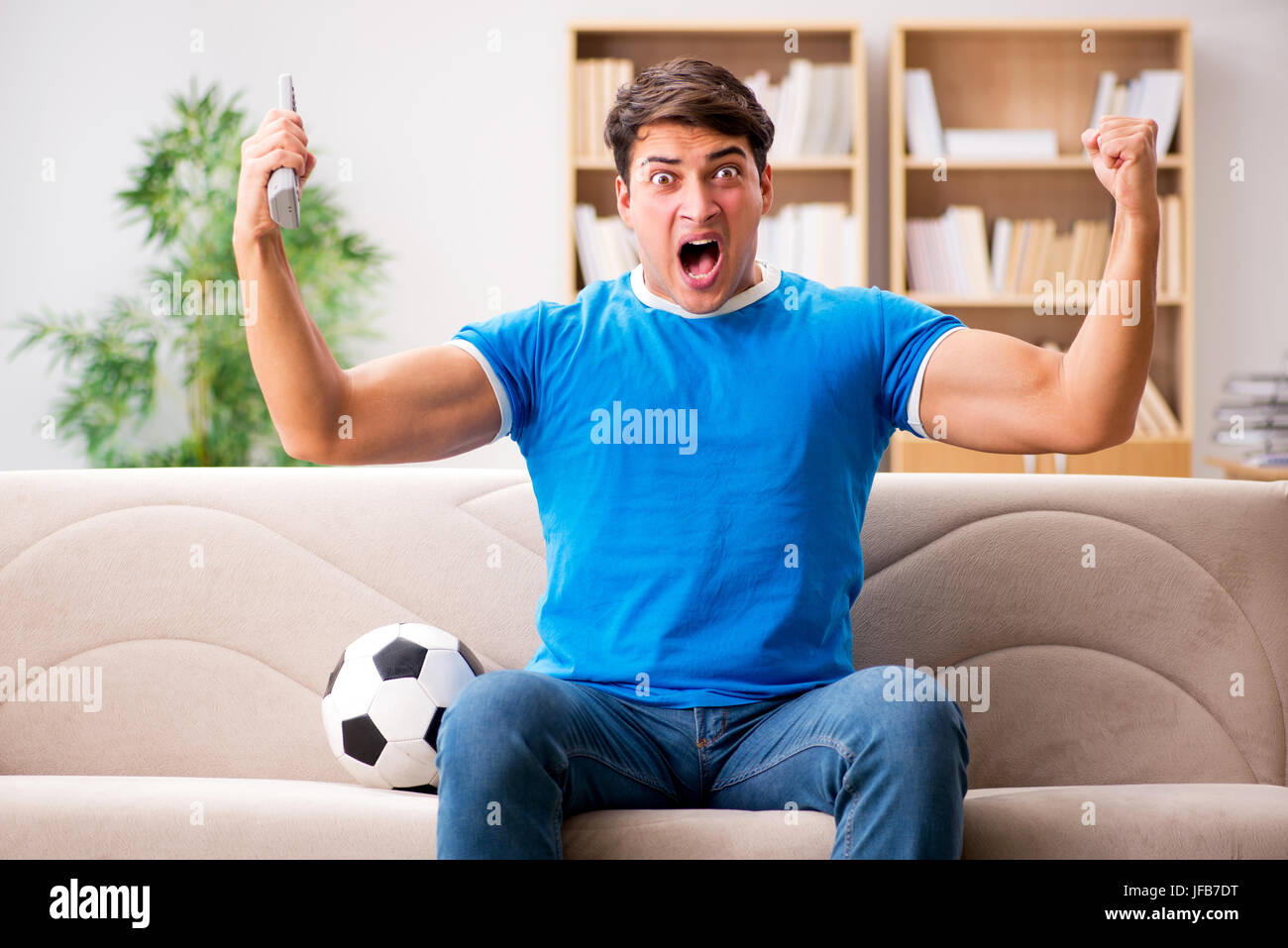 Man watching football at home Stock Photo - Alamy