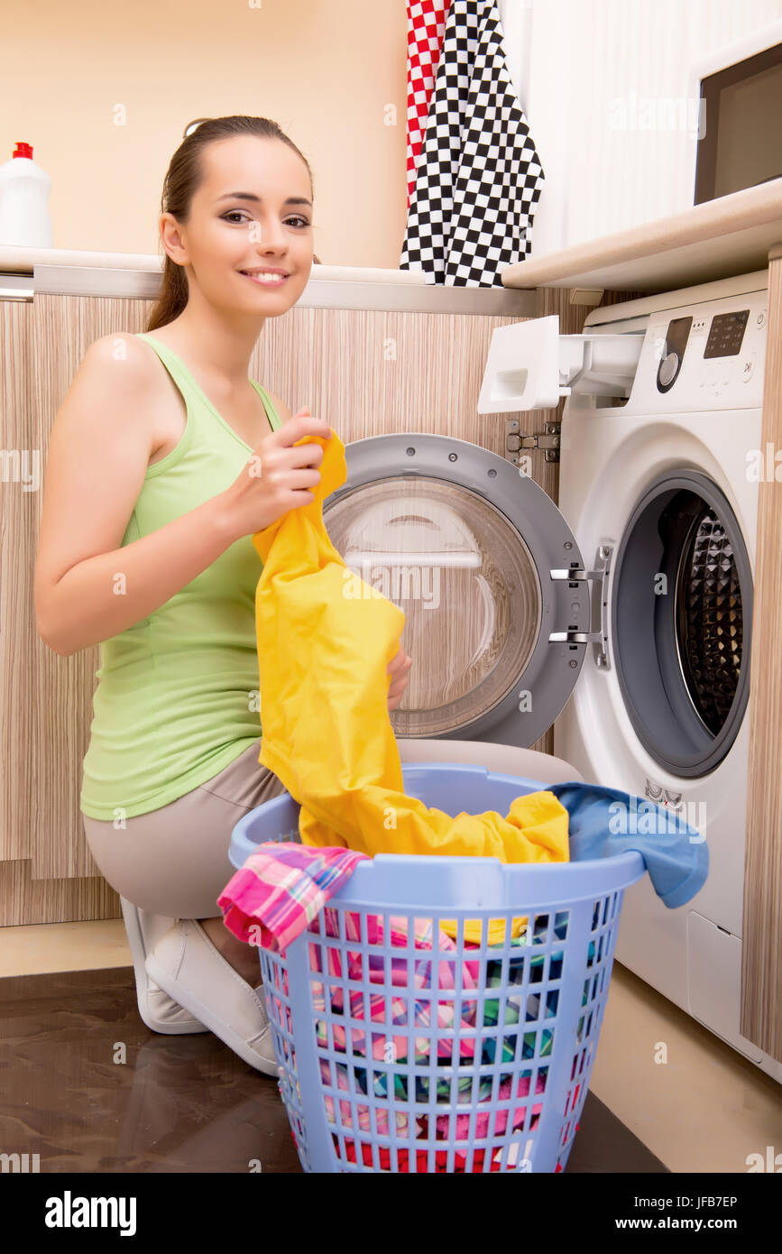 Woman doing laundry at home Stock Photo - Alamy