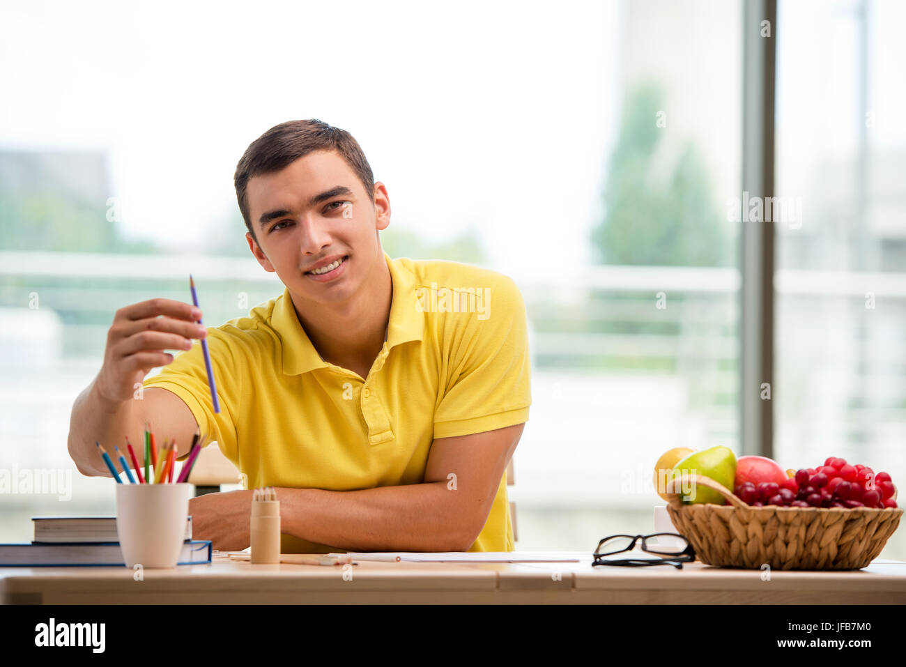 Young man drawing pictures in studio Stock Photo - Alamy