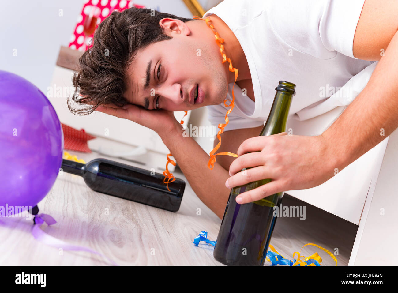 Man after heavy christmas partying at home Stock Photo - Alamy