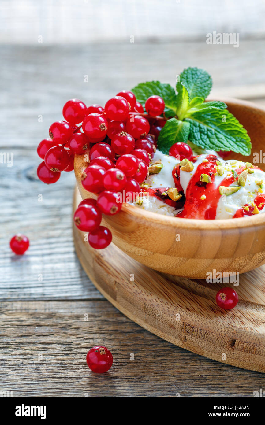 Red currants, mint and ice cream in a wooden bowl Stock Photo - Alamy