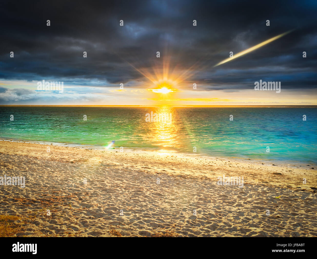 Le Morn beach at sunset Stock Photo - Alamy