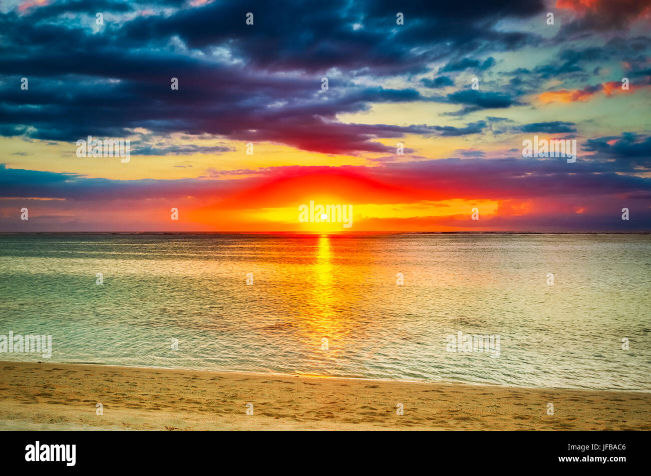 Le Morn beach at sunset Stock Photo - Alamy