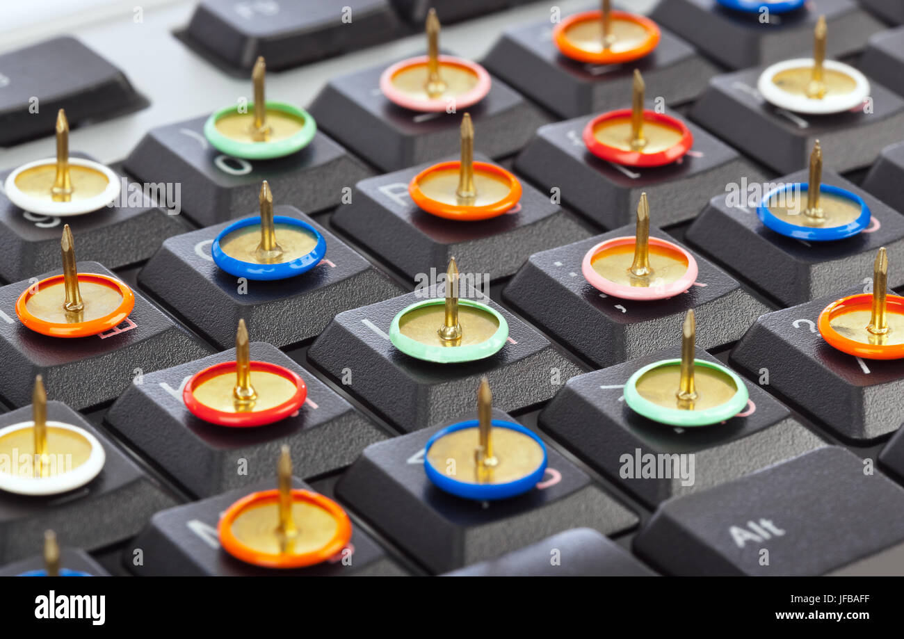 Pins on computer keyboard Stock Photo - Alamy