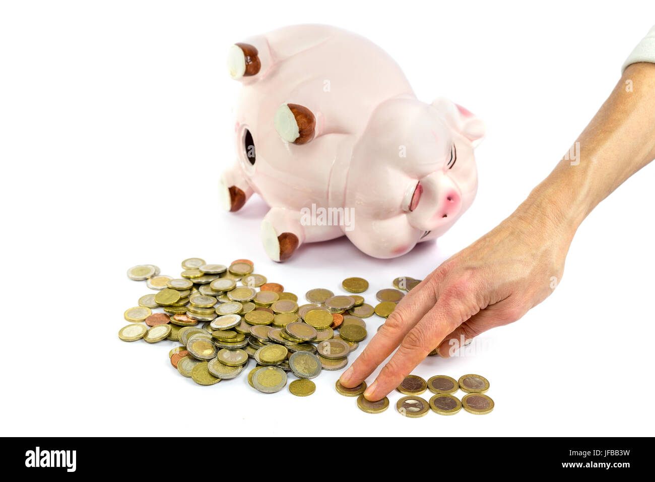 Hand counting euro coins from piggy bank Stock Photo - Alamy