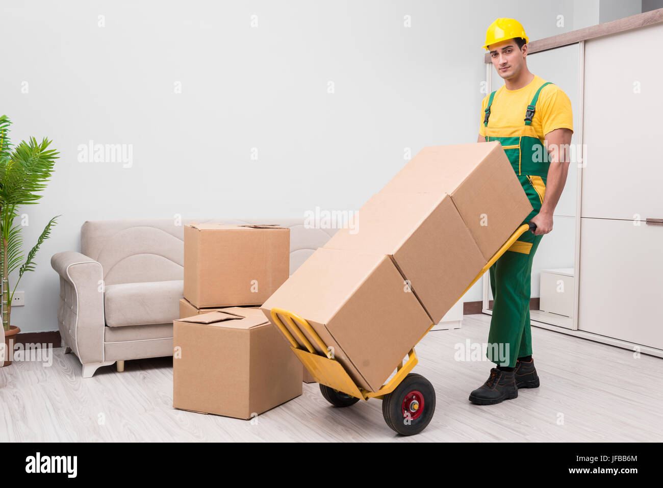 Man delivering boxes during house move Stock Photo - Alamy