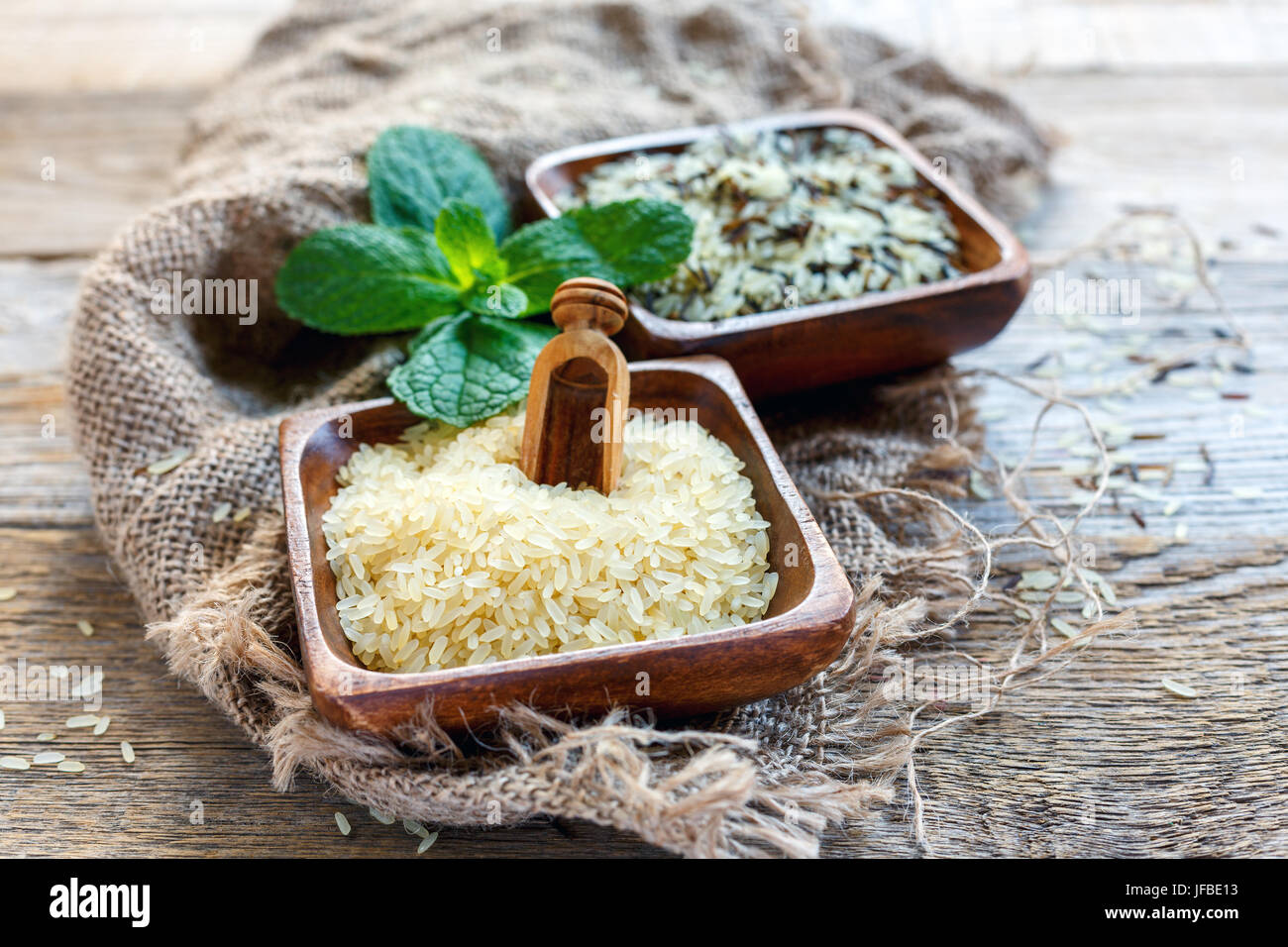 Wooden bowls with rice on the old sacking Stock Photo - Alamy