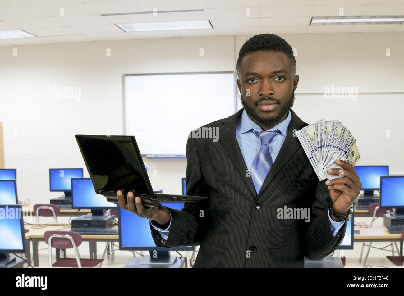 Man with computer and cash Stock Photo - Alamy
