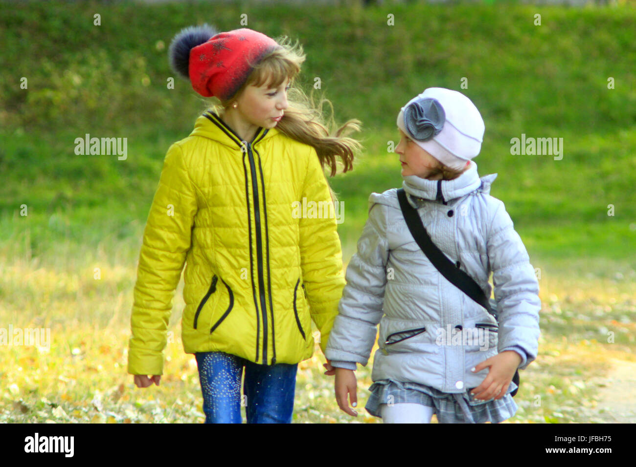 two girls talk to each other outside Stock Photo - Alamy