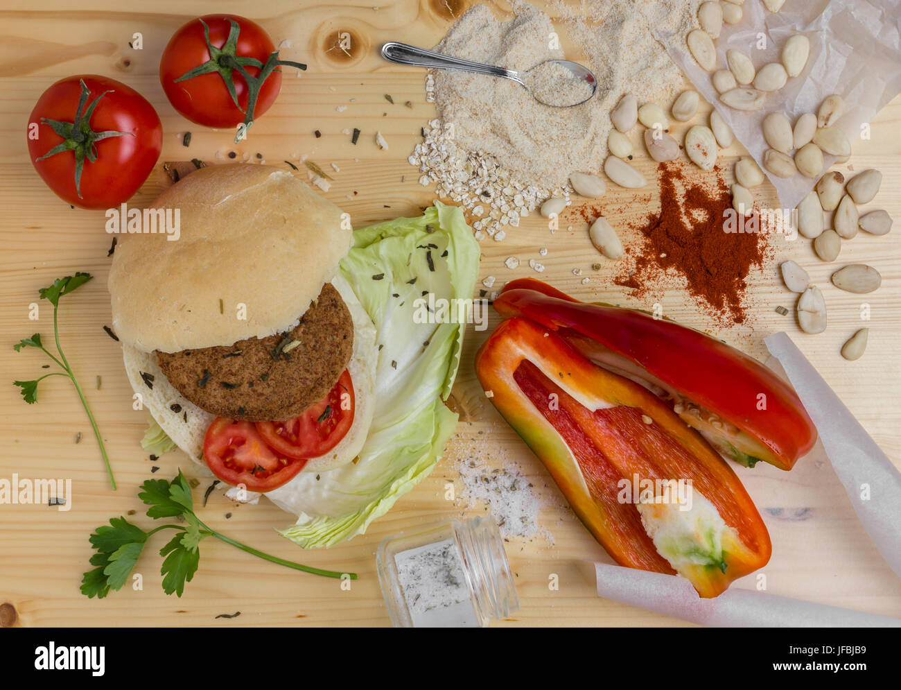 Homemade veg burger with ingredients, on a light wooden background. Top ...