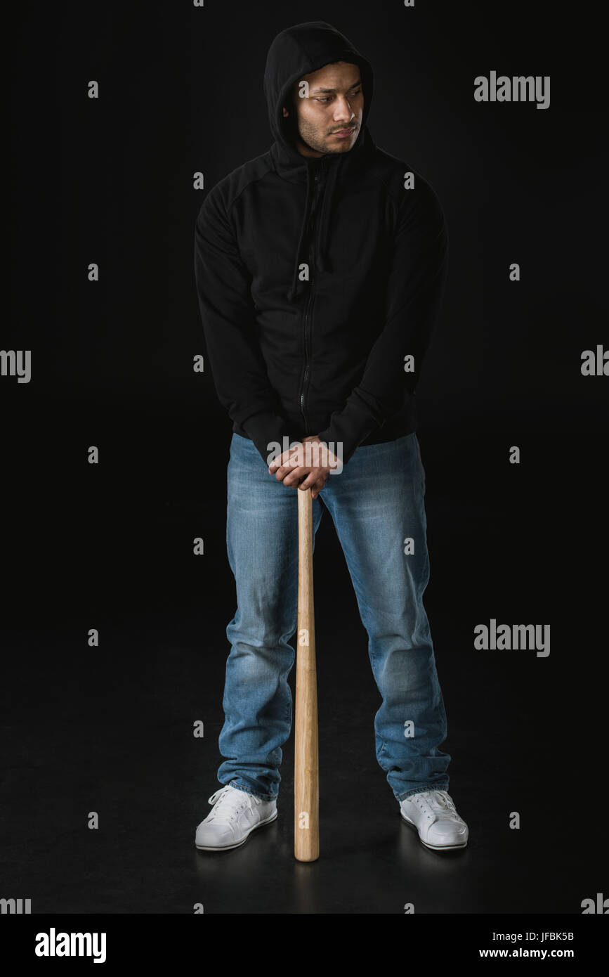 young african american robber in zoodie with baseball bat isolated on ...