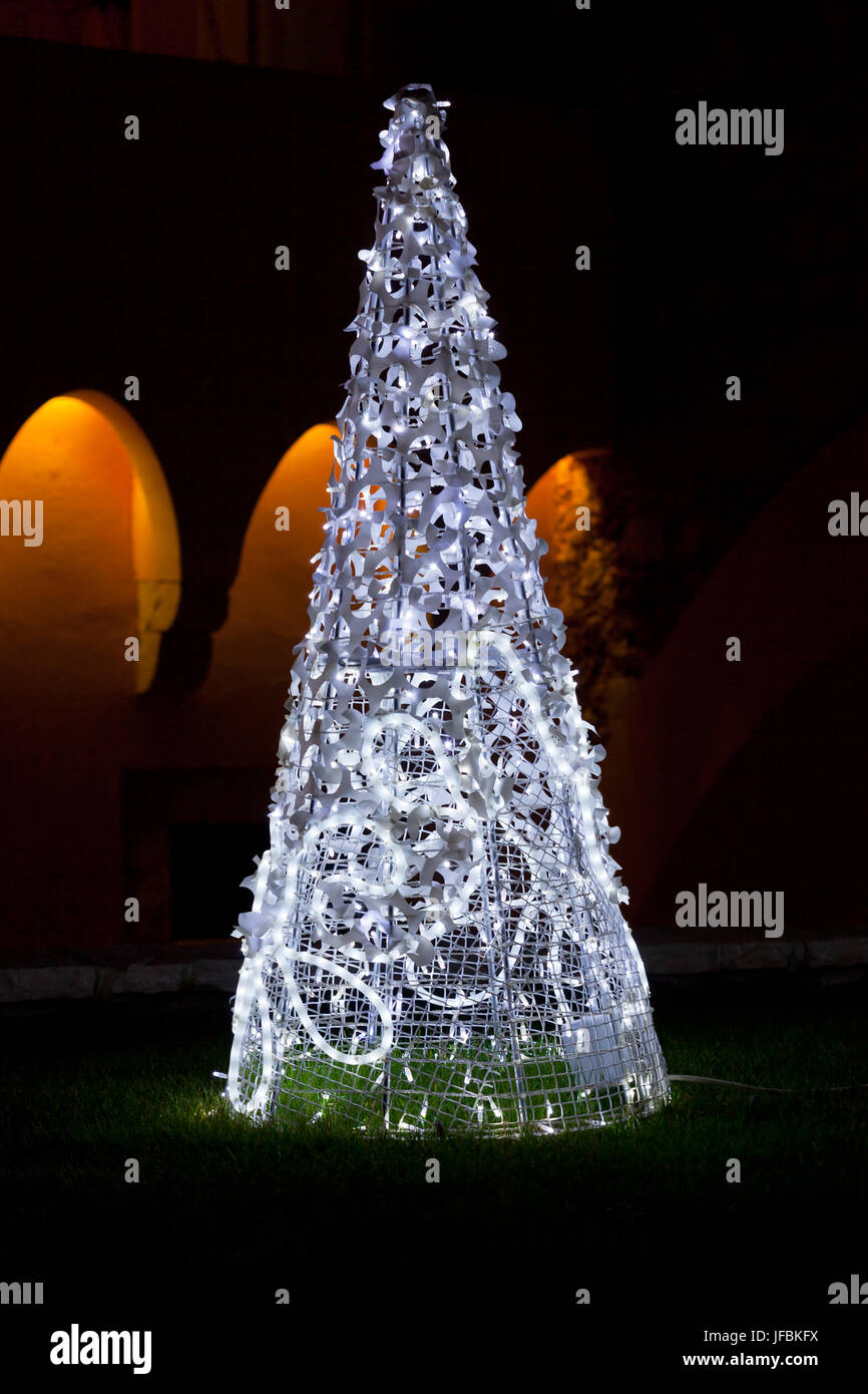 Outdoor Pine christmas tree figure with white lights Stock Photo - Alamy
