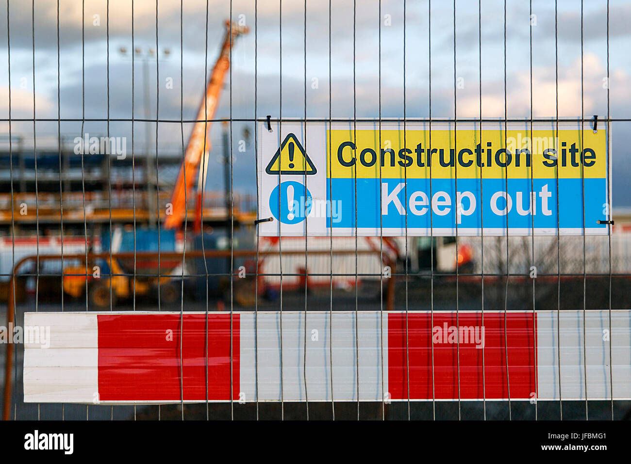 Construction site warning signs in yellow and blue instructing people ...