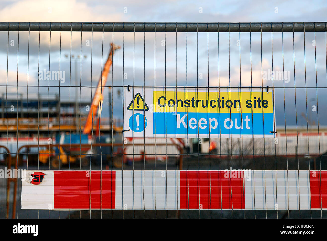 Construction site warning signs in yellow and blue instructing people ...
