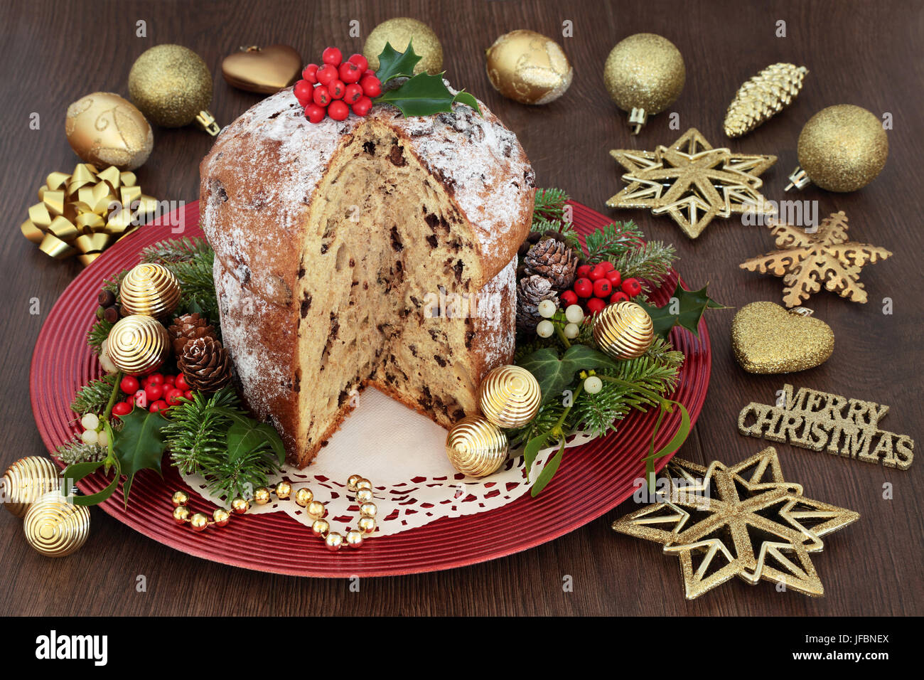 Chocolate panettone christmas cake with gold bauble decorations, holly ...