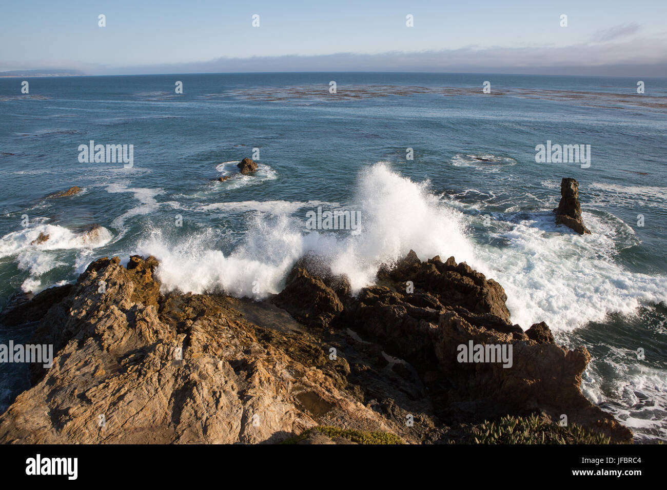 Waves crash onto rock formations on a Pacific coast Stock Photo - Alamy