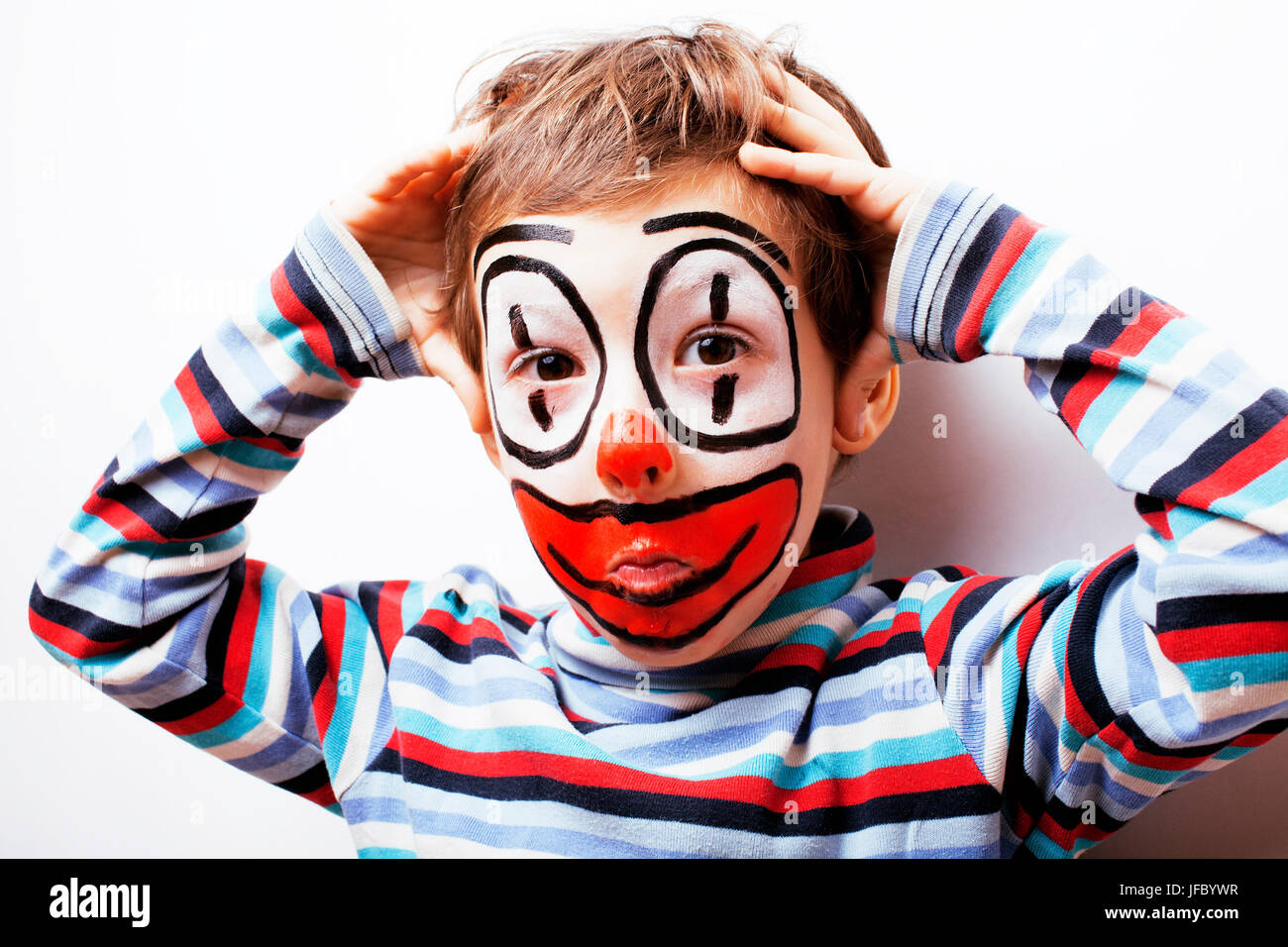 little cute real boy with facepaint like clown, pantomimic expressions ...
