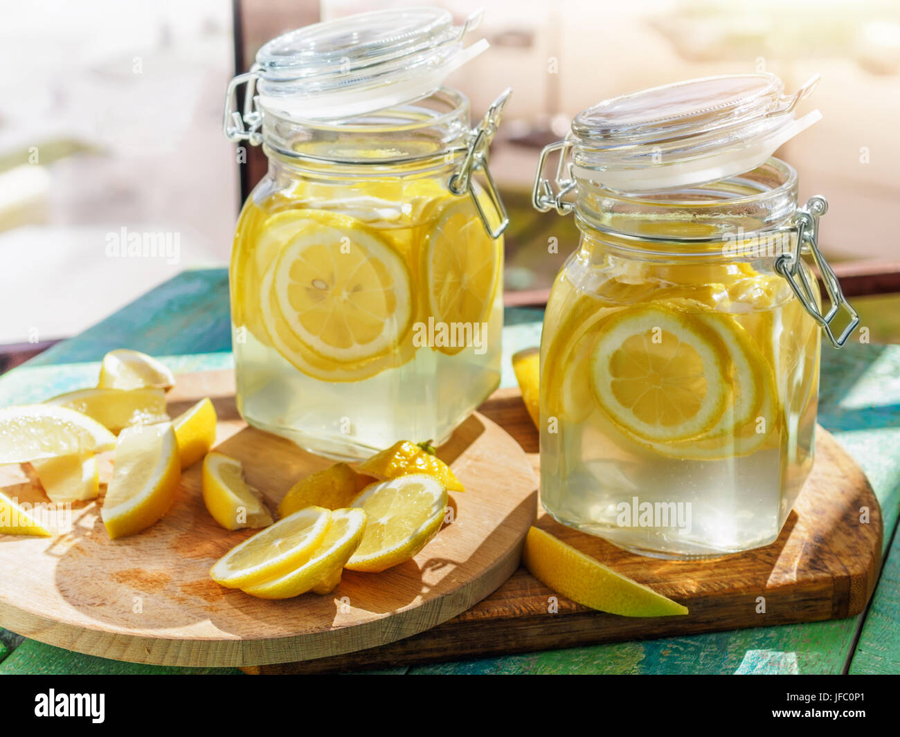Cold Lemonade ice, in jugs, straw, urban view, sunshine wooden ...