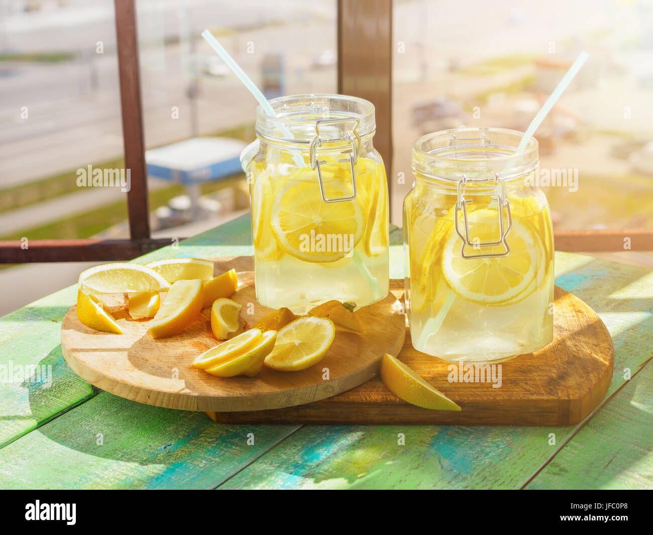 Cold Lemonade ice, in jugs, straw, urban view, sunshine wooden ...