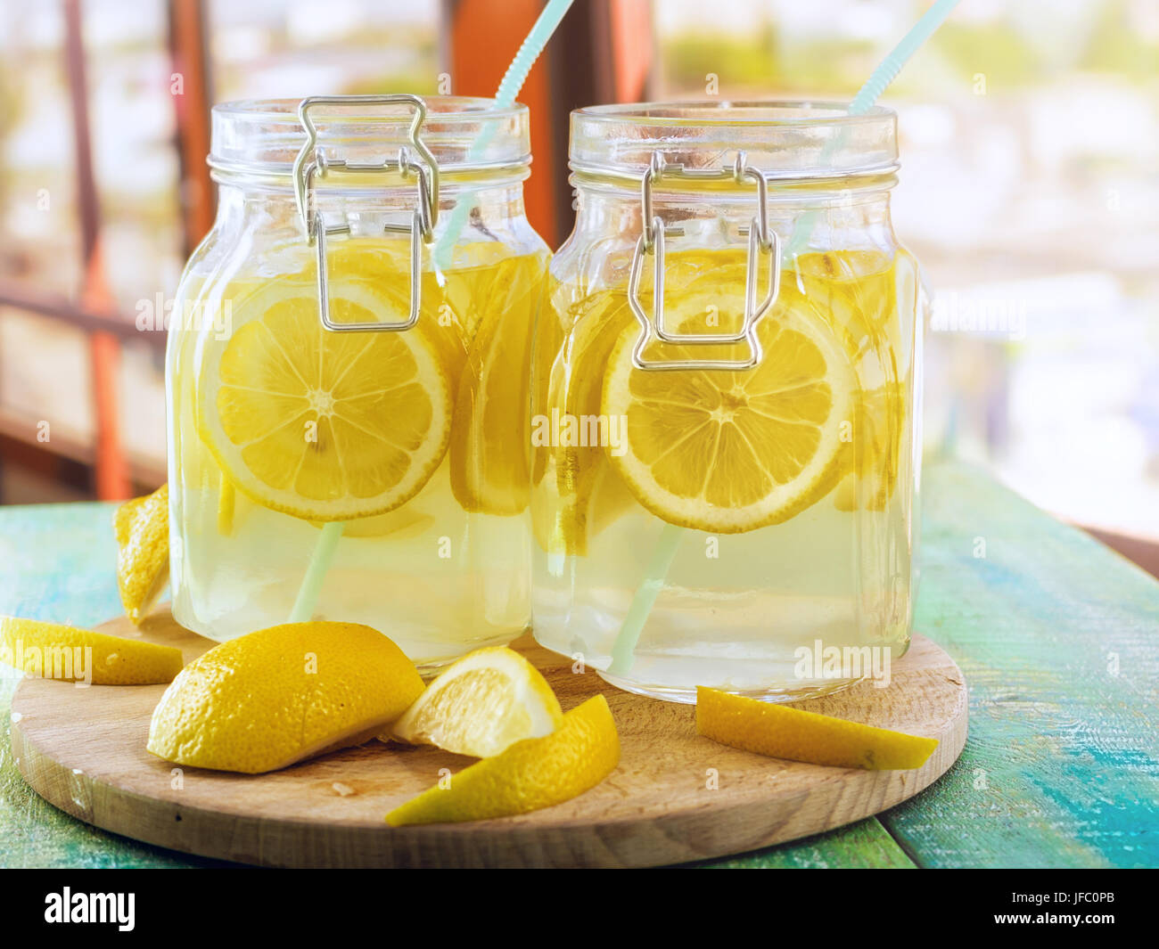 Cold Lemonade ice, in jugs, straw, urban view, sunshine wooden ...