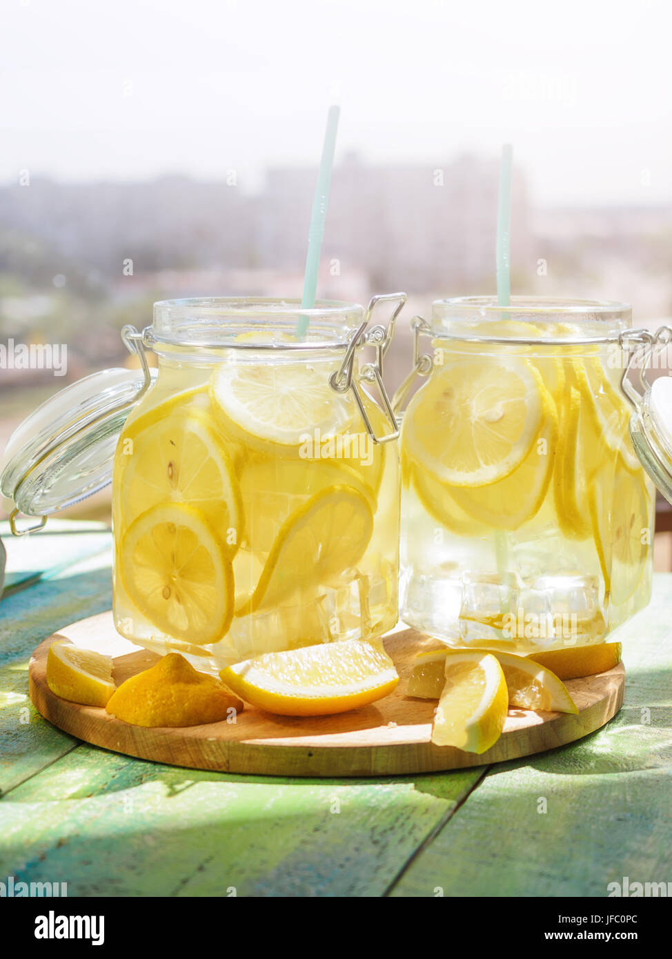 Cold Lemonade ice, in jugs, straw, urban view, sunshine wooden ...