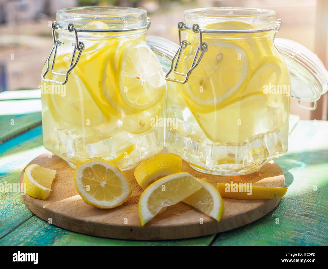 Cold Lemonade ice, in jugs, straw, urban view, sunshine wooden ...