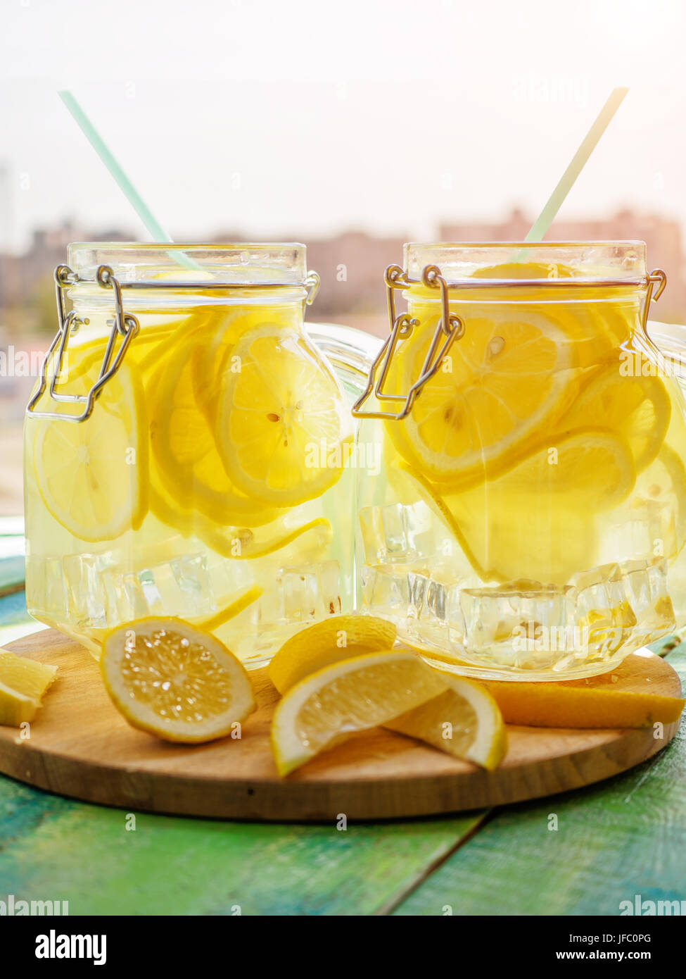 Cold Lemonade ice, in jugs, straw, urban view, sunshine wooden ...