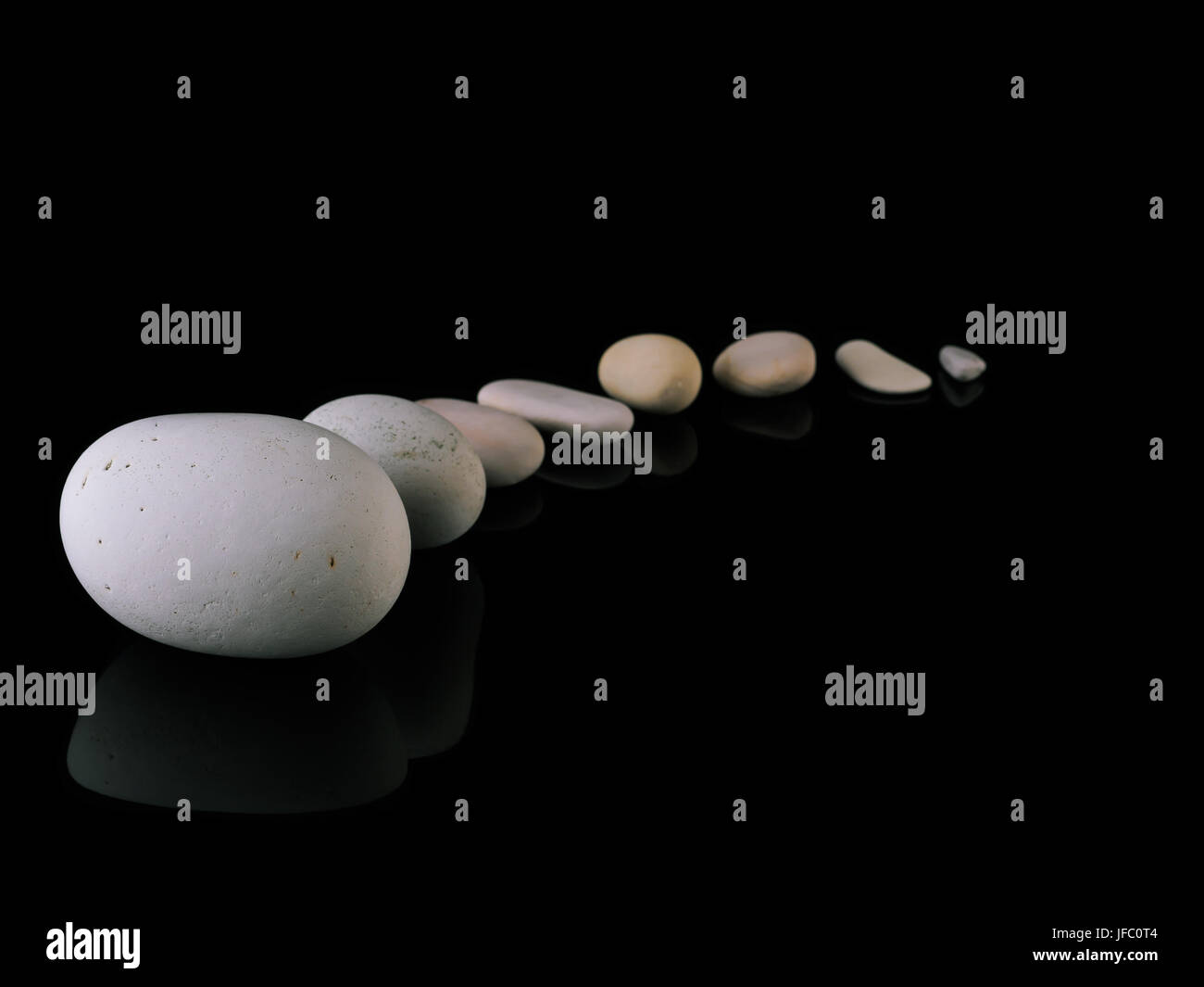Zen stones calm rocks mindfulness Spa in stack on black background with ...