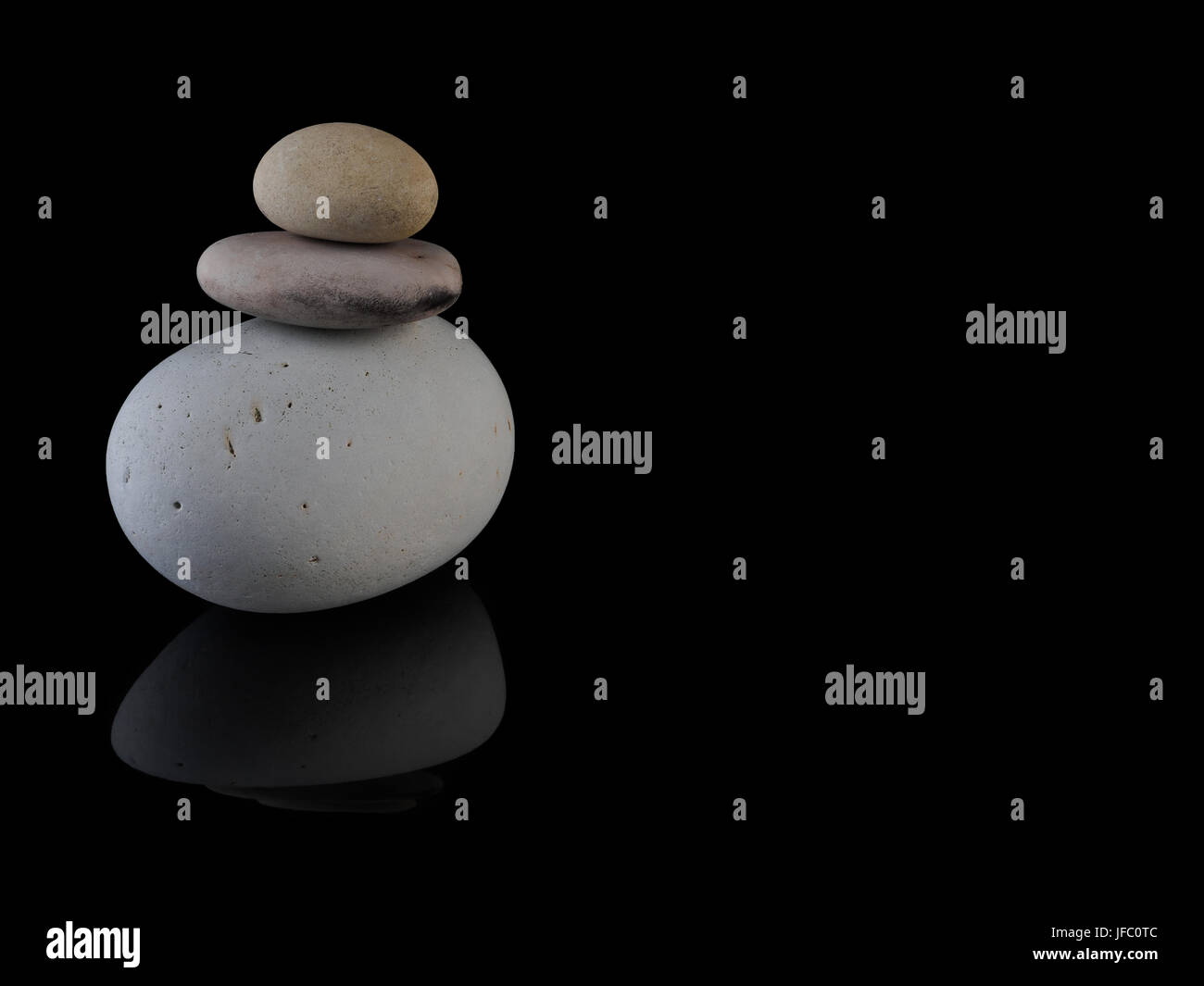 Zen stones calm rocks mindfulness Spa in stack on black background with ...