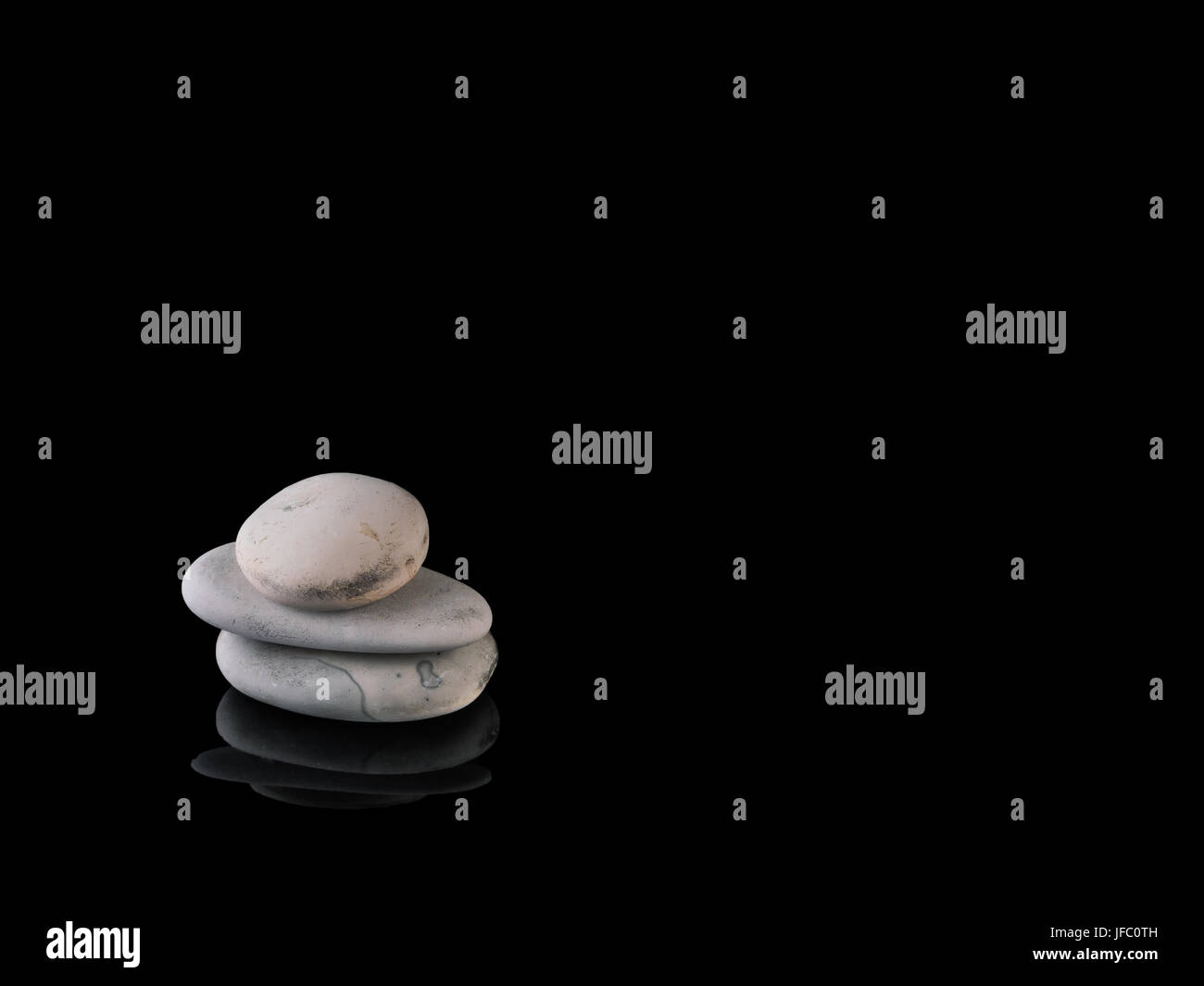 Zen stones calm rocks mindfulness Spa in stack on black background with ...