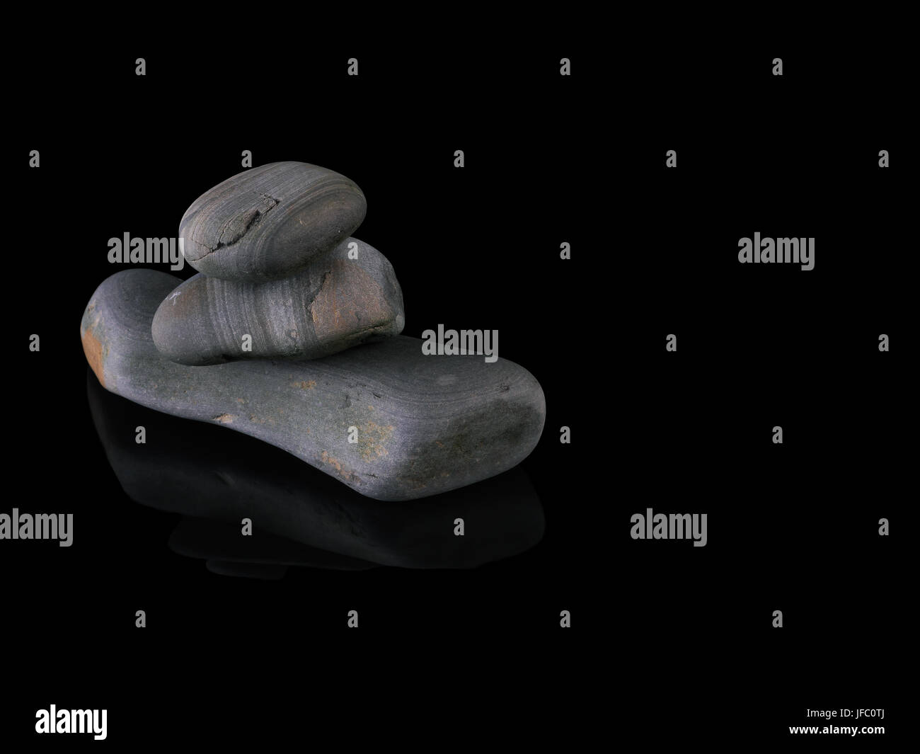 Zen stones calm rocks mindfulness Spa in stack on black background with ...