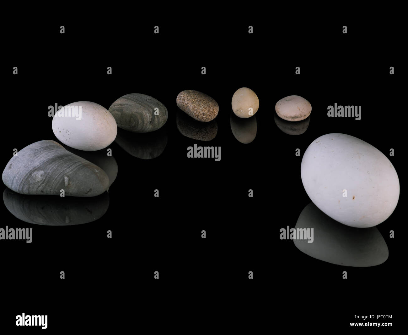 Zen stones calm rocks mindfulness Spa in stack on black background with ...