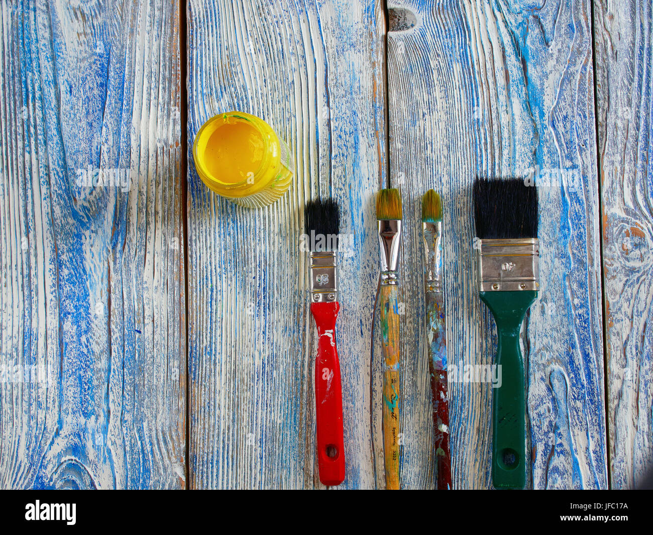 Acrylic paints and colored brushes on an authentic background of hand ...