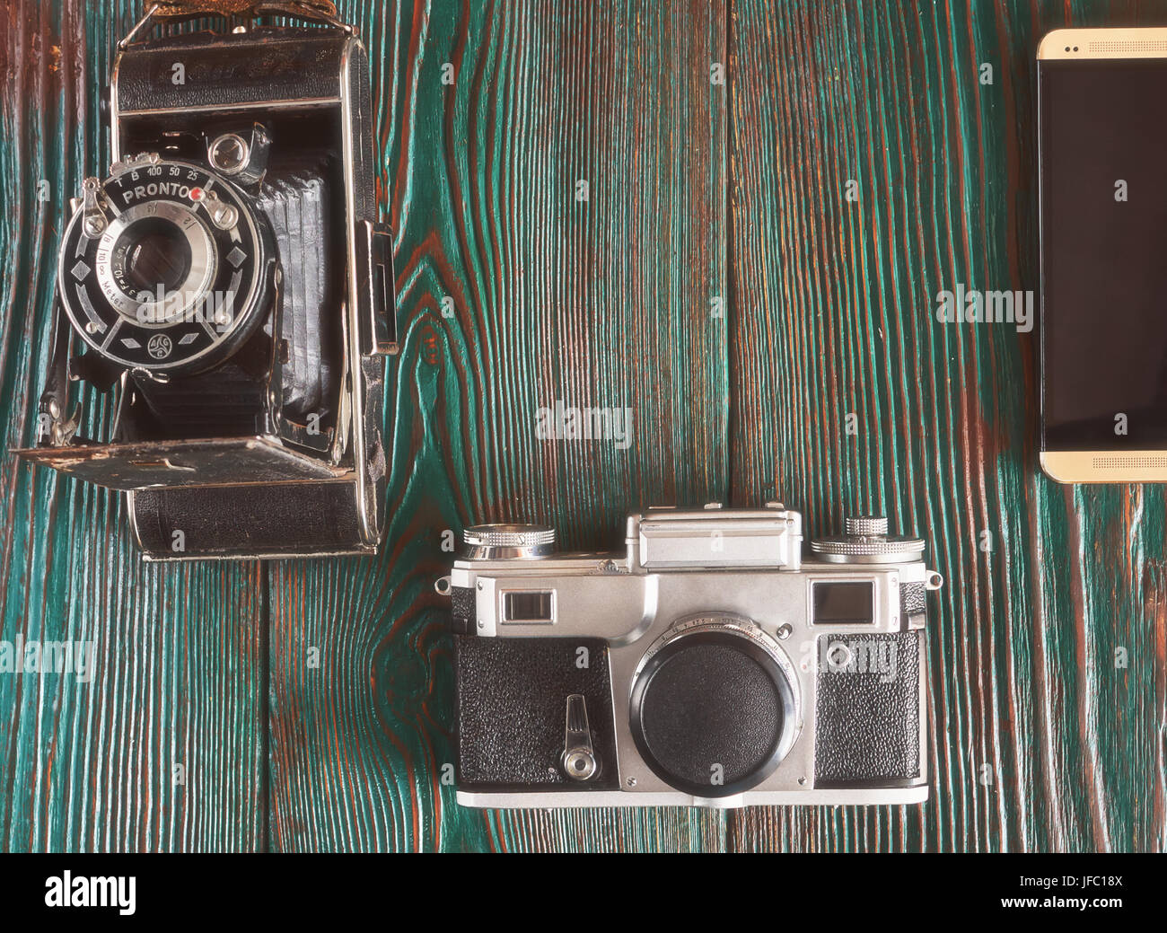 Three generations of a photo cameras and old photos on memory. Ancient ...