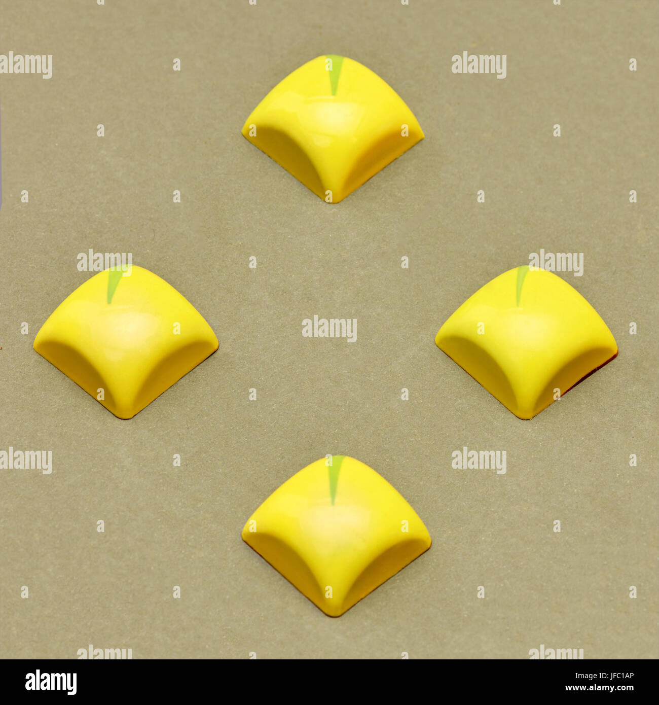 Four square yellow sweets Stock Photo - Alamy