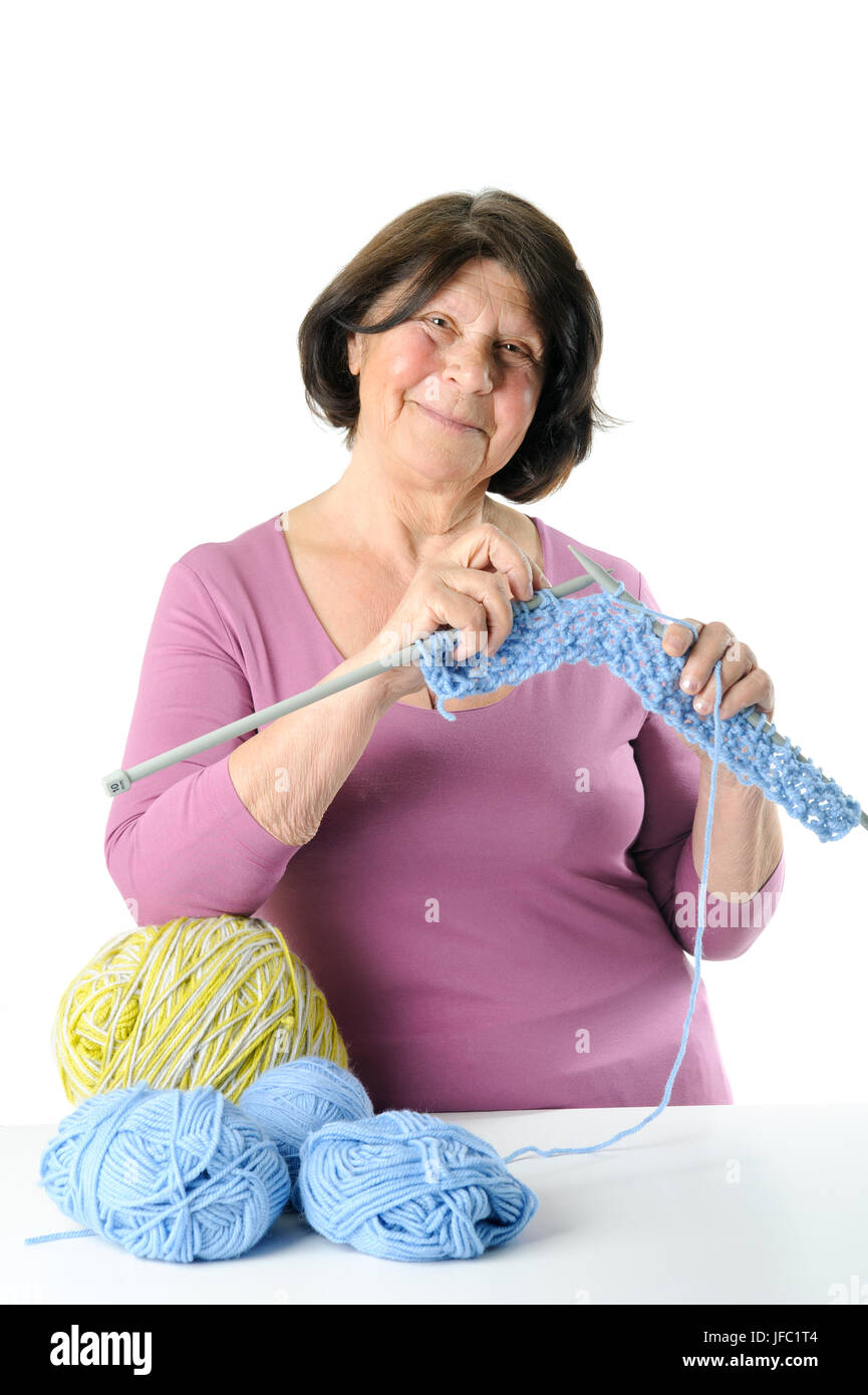 Happy elderly woman is engaged in knitting Stock Photo - Alamy