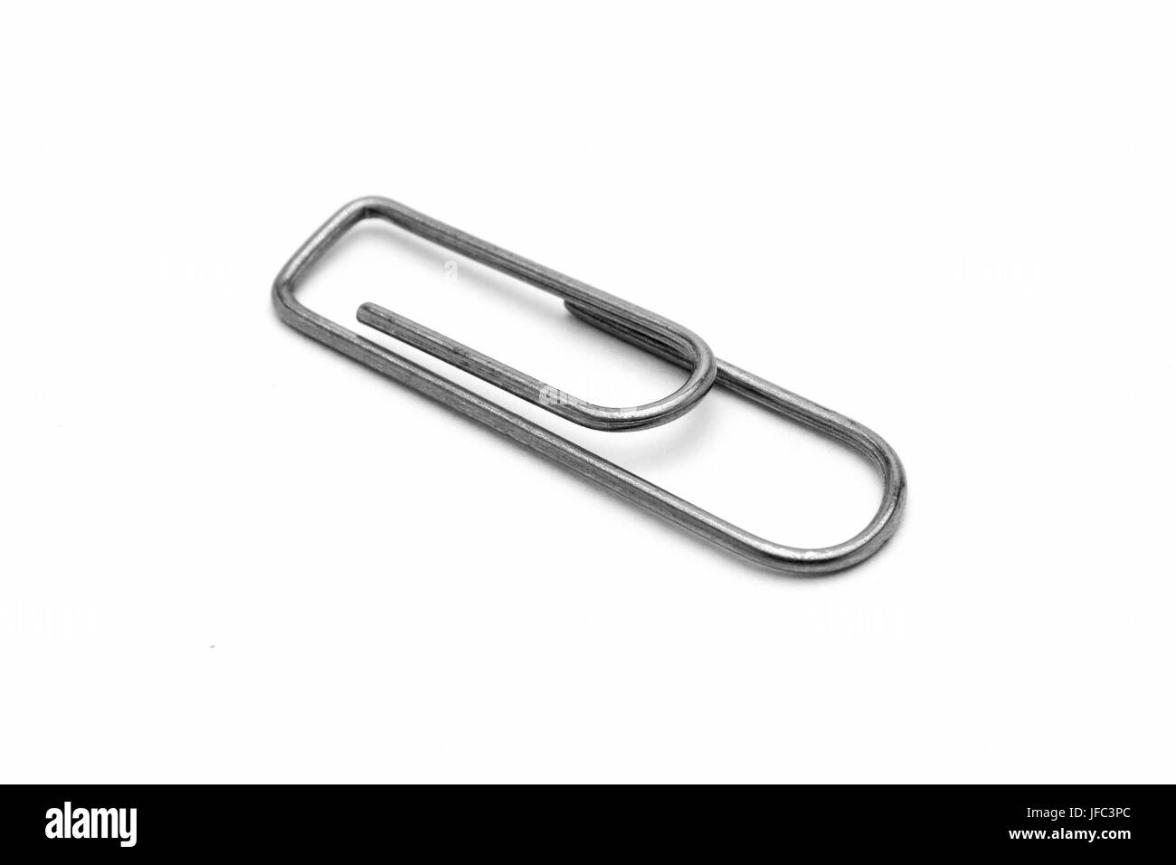 Steel paper clip close up on a white background Stock Photo - Alamy