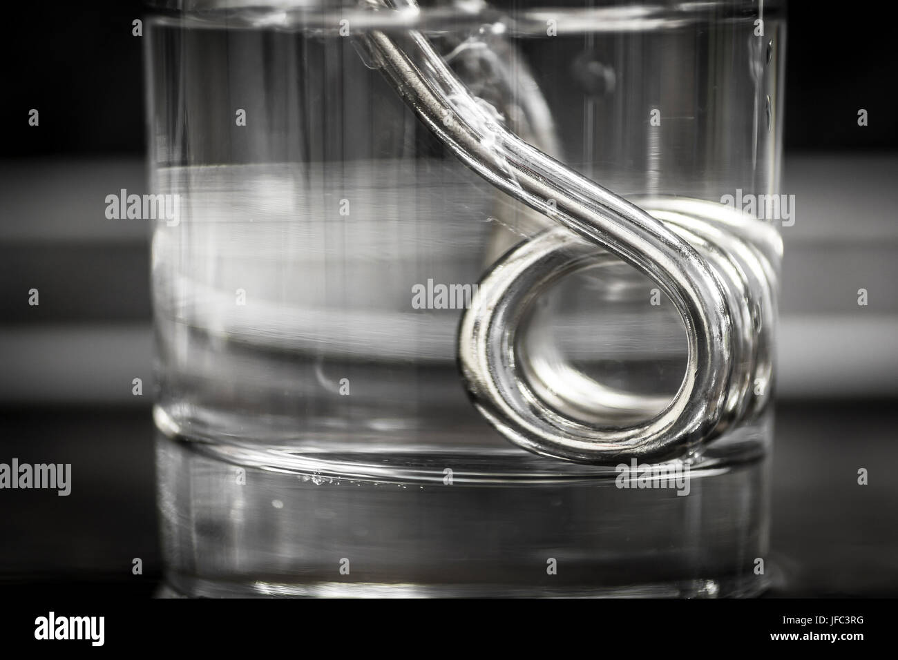 The heating coil heats the water in the beaker to boiling Stock Photo ...