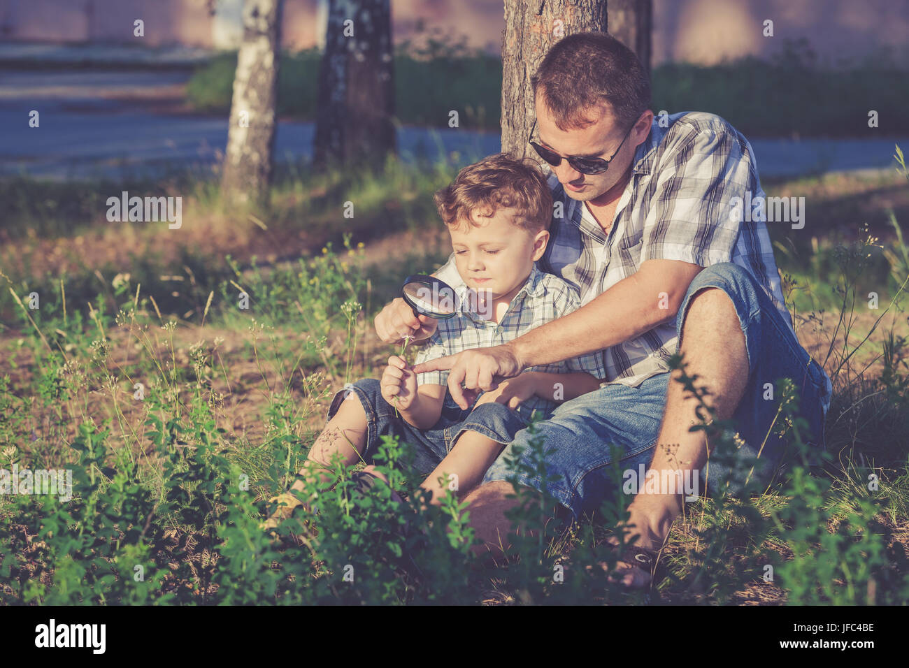 Father and son playing in the park at the day time. Concept of friendly ...