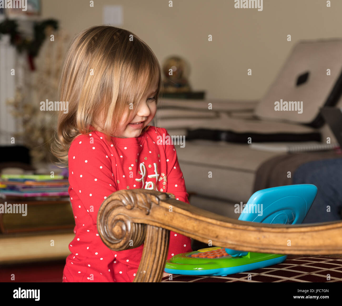 Young girl toddler playing with toy computer Stock Photo - Alamy