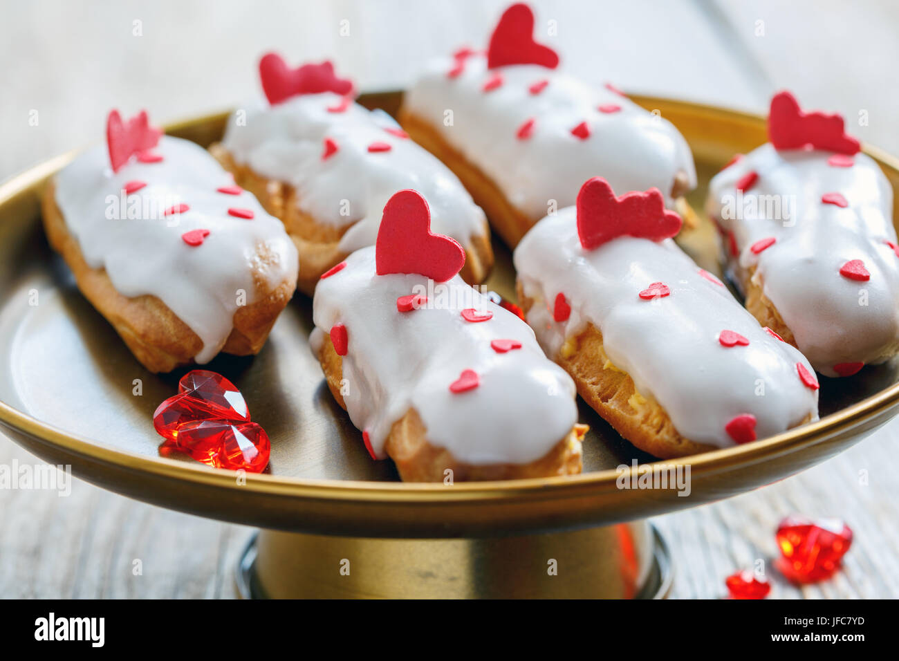 Vanilla eclairs with the decor of hearts Stock Photo - Alamy