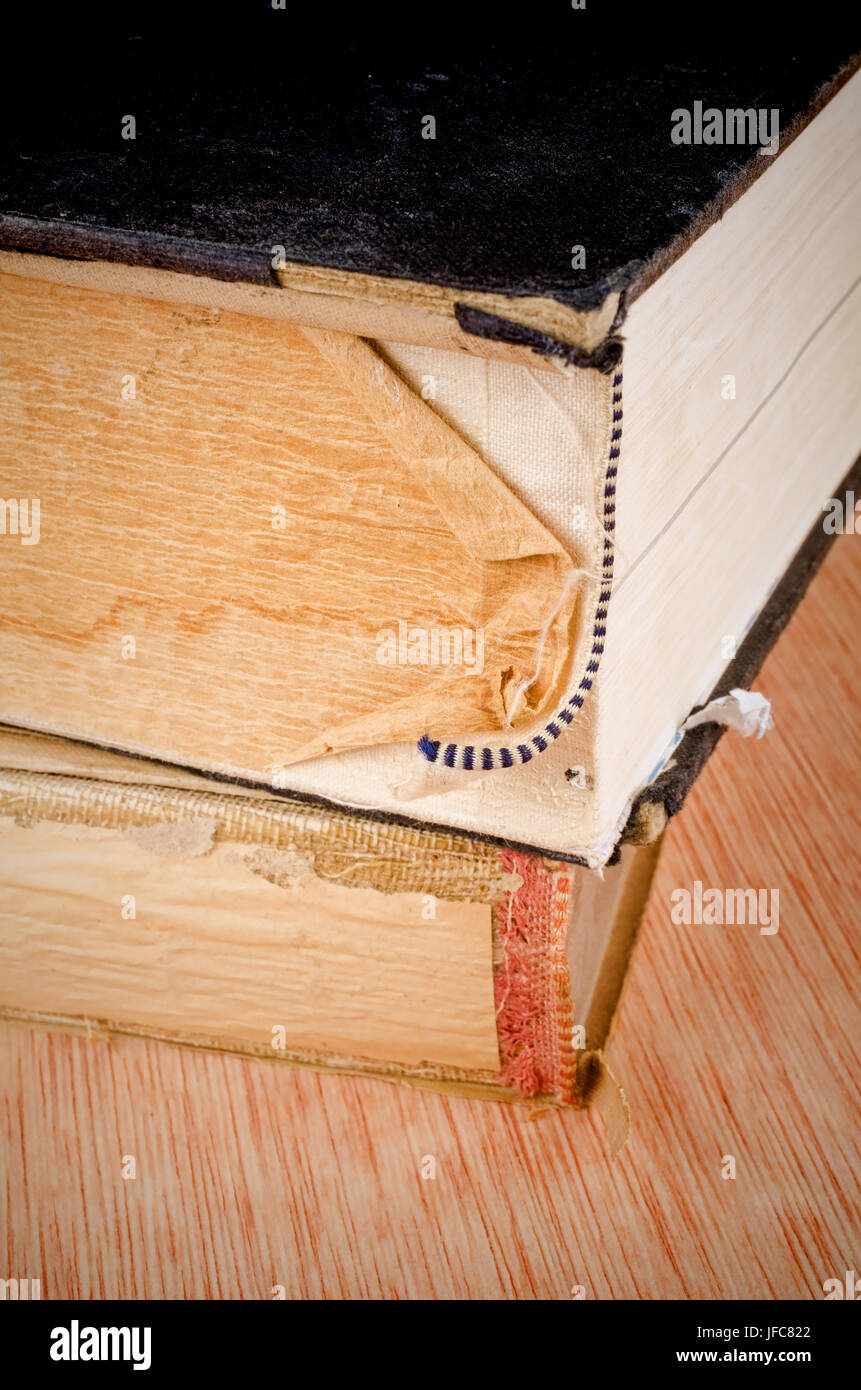 Stack of old books with damaged binding Stock Photo - Alamy