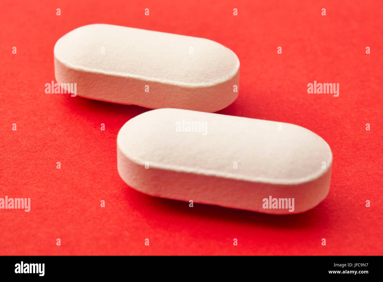 Pills over a red background. Medicament treatment. Health care photo ...