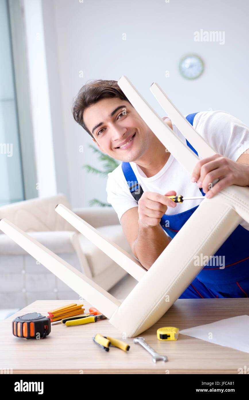 Man repairing chair in the room Stock Photo - Alamy