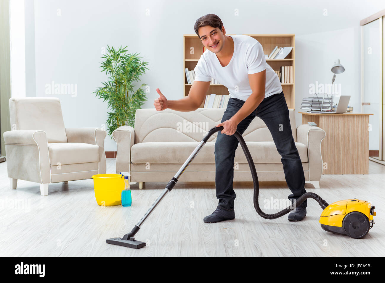 Man husband cleaning the house helping wife Stock Photo - Alamy