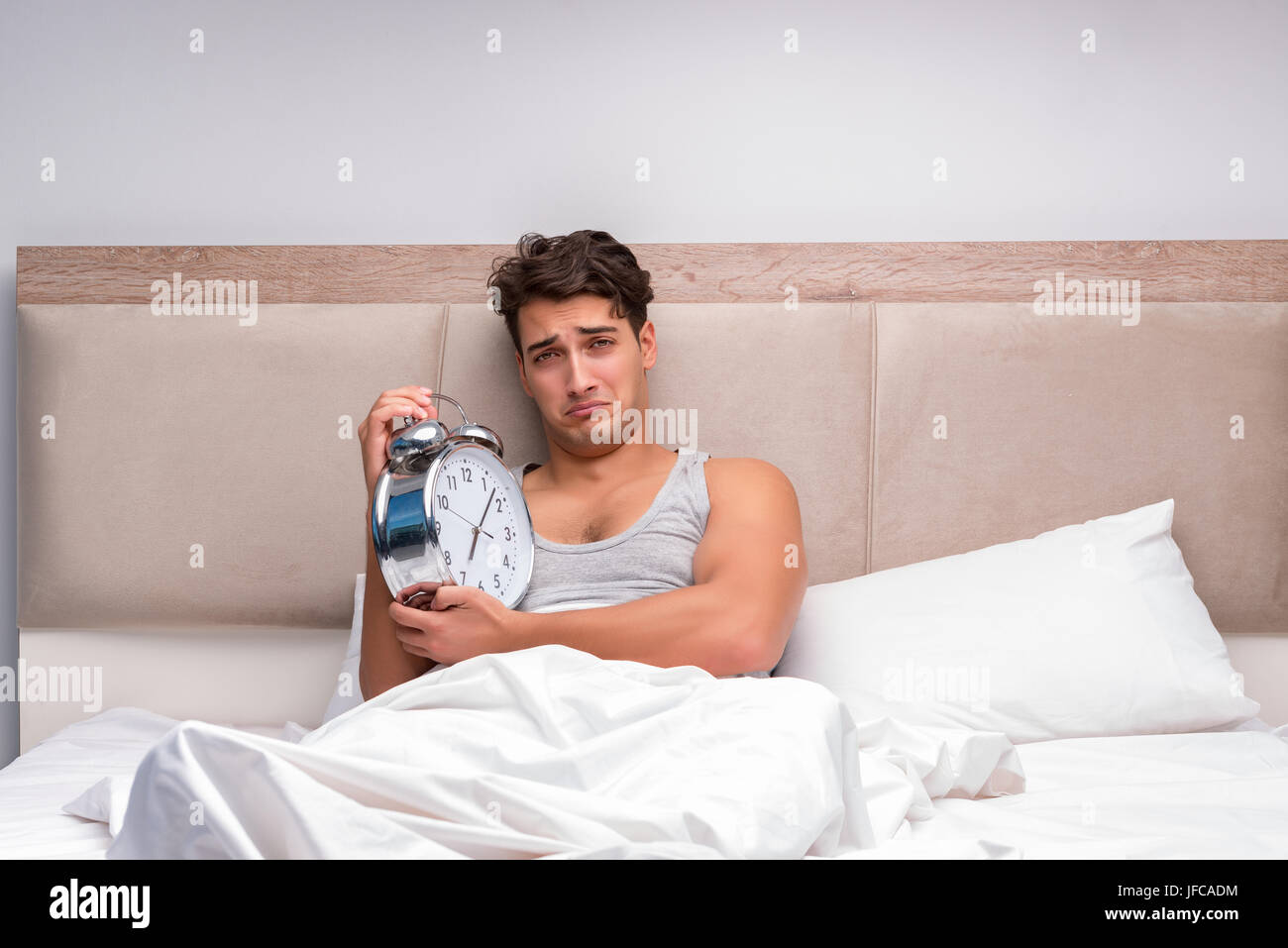 Man having trouble waking up in the morning Stock Photo - Alamy