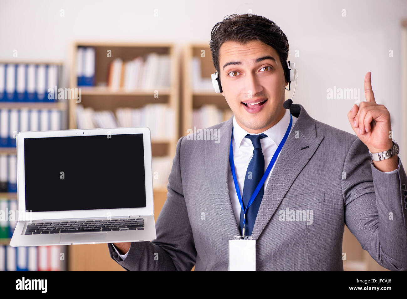 Handsome customer service clerk with headset Stock Photo - Alamy