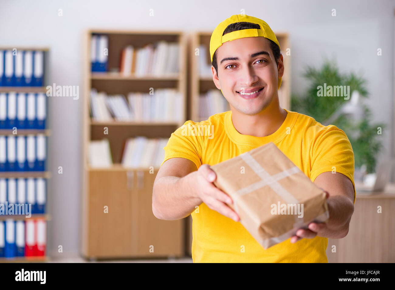Delivery man delivering parcel box Stock Photo - Alamy