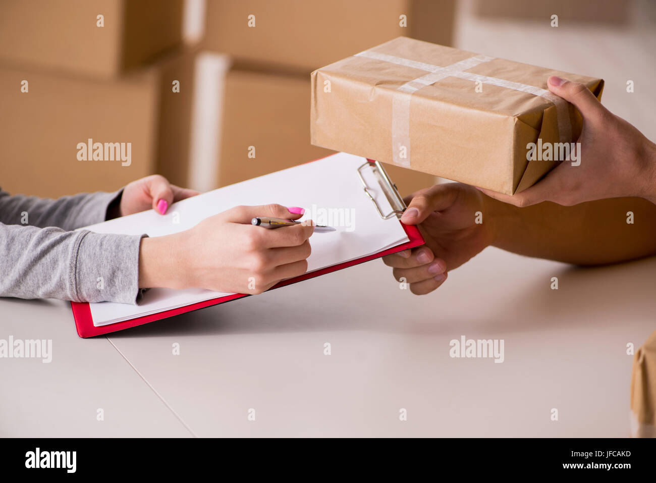 Delivery man delivering parcel box Stock Photo - Alamy