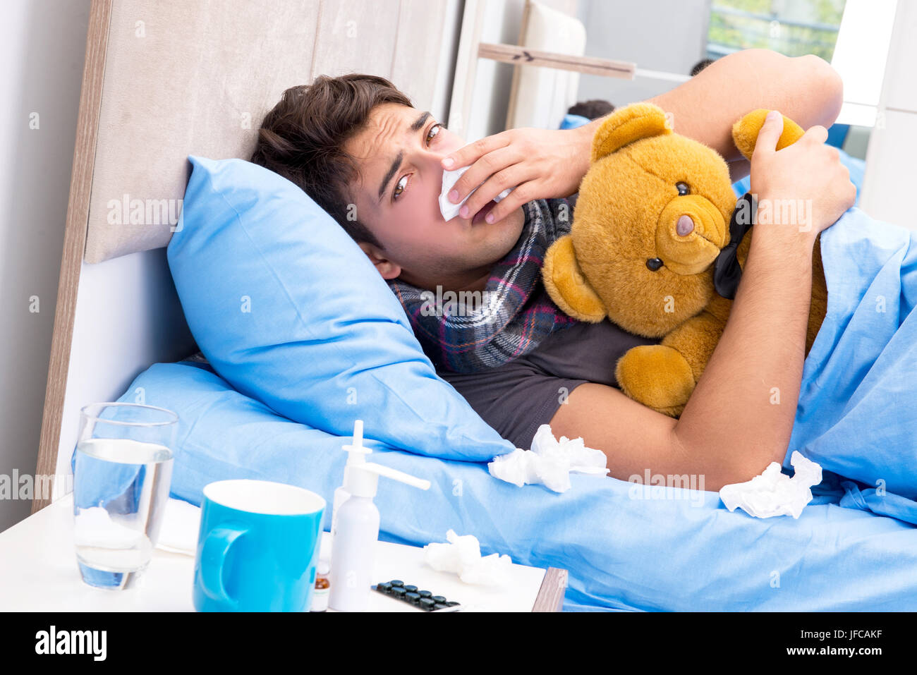 Sick man with flu lying in the bed Stock Photo - Alamy